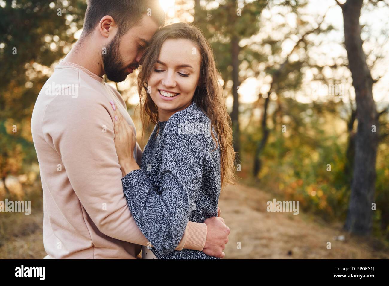 Embraces each other. Cheerful lovely young couple having a rest ...