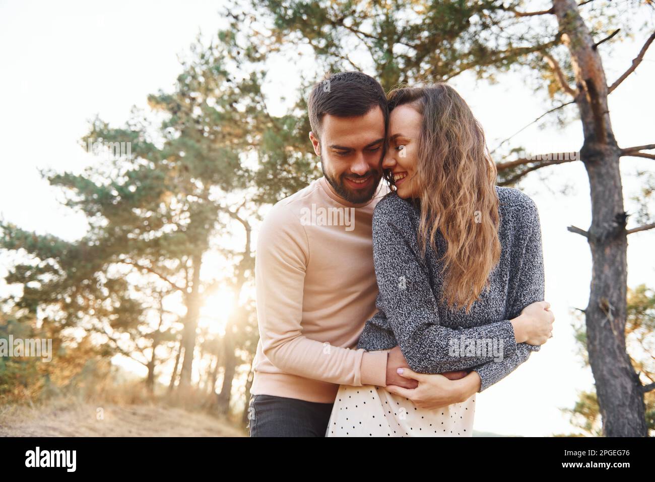 Embraces each other. Cheerful lovely young couple having a rest ...