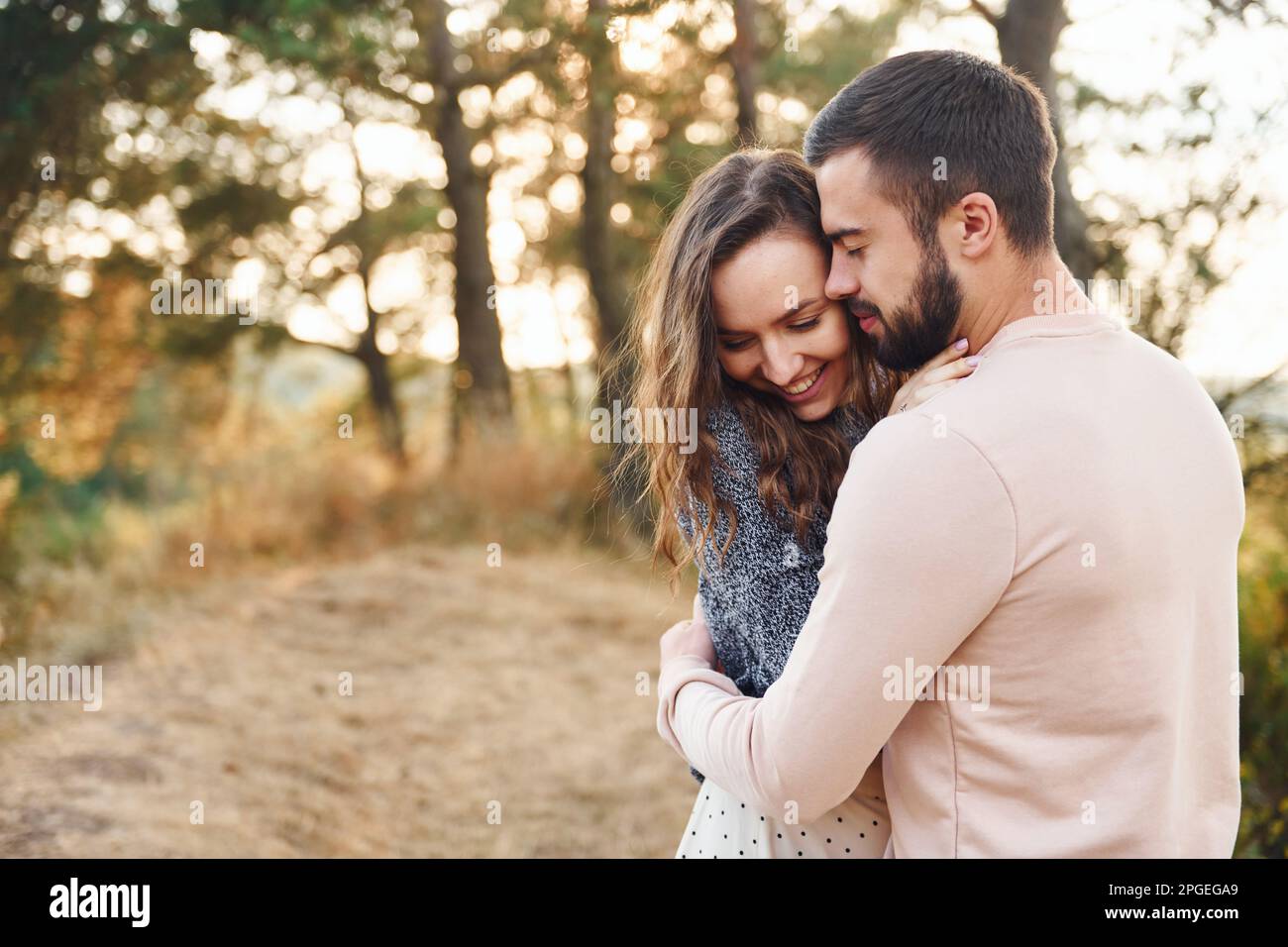 Embraces each other. Cheerful lovely young couple having a rest ...
