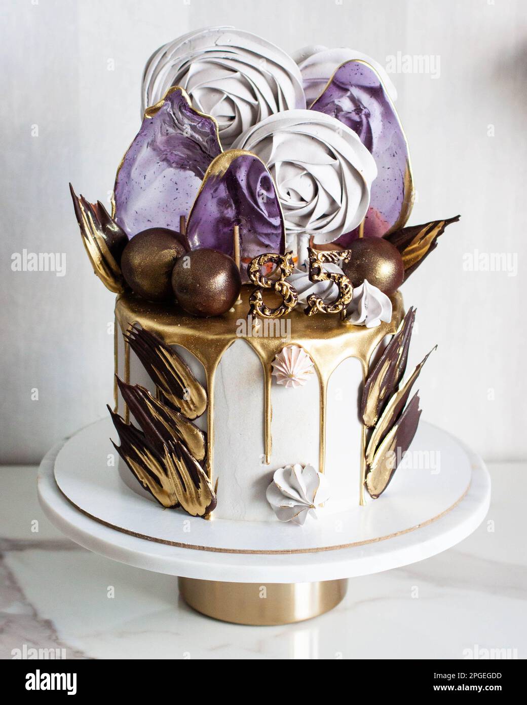 Tender pink cake decorated with melted white chocolate, macaroons ...