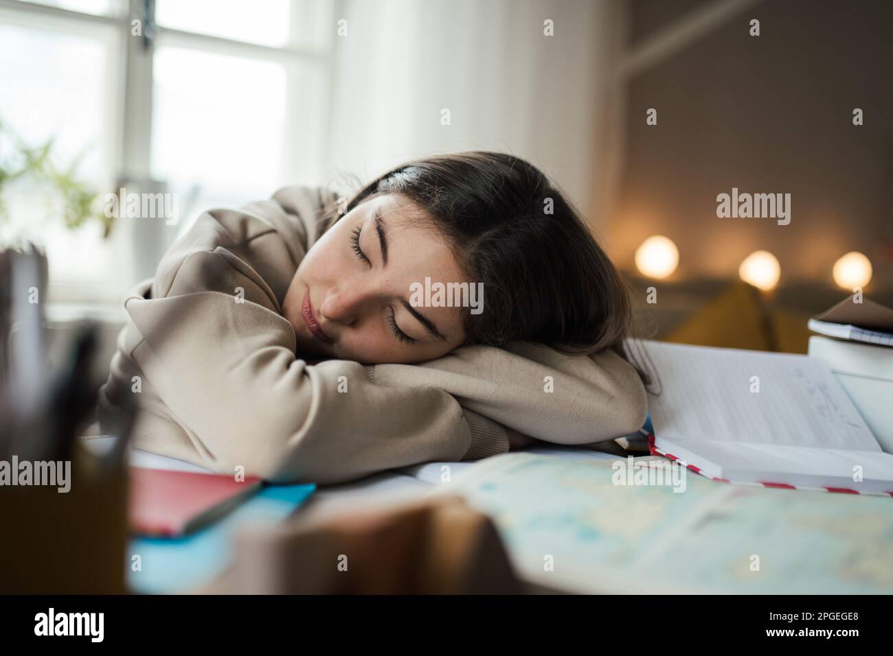 Teenage girl fall asleep during studying in her room Stock Photo - Alamy