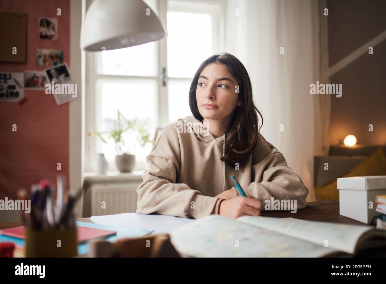 Young teenage girl studying in her room Stock Photo - Alamy