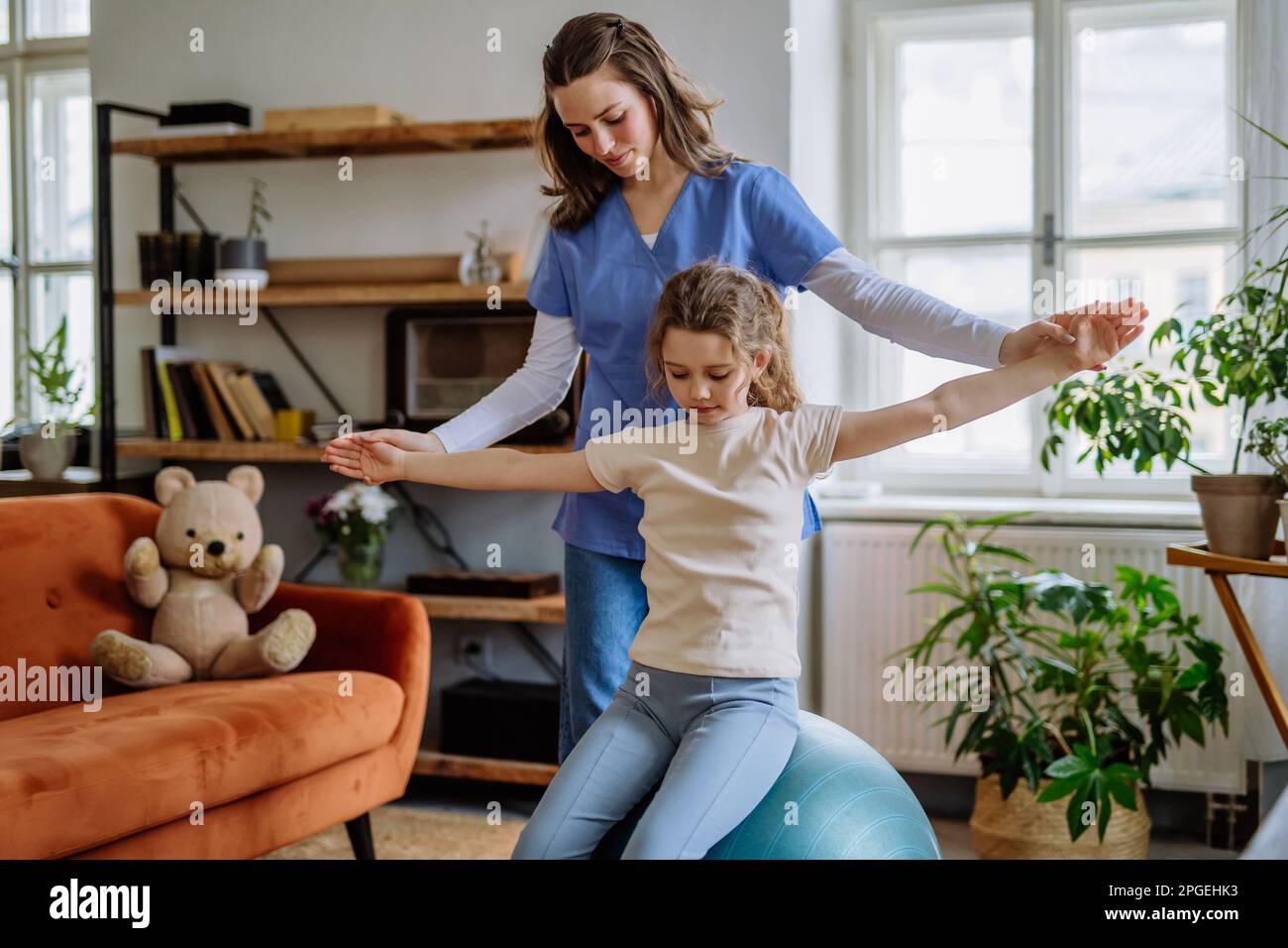 Little girl doing exercise with a nurse Stock Photo - Alamy