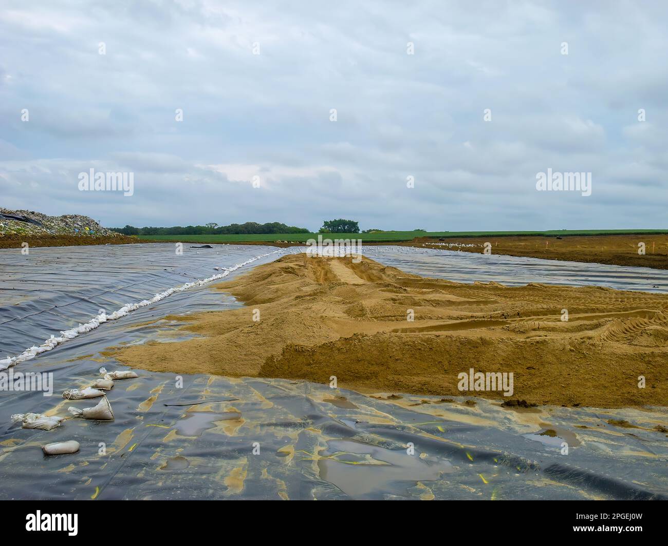Landfill expansion project with sand drainage layer being placed over a ...