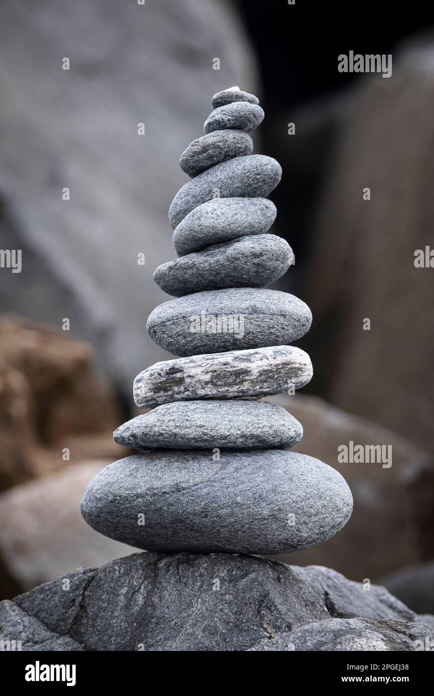 A stack of smooth stones balanced on top of a rocky surface Stock Photo ...