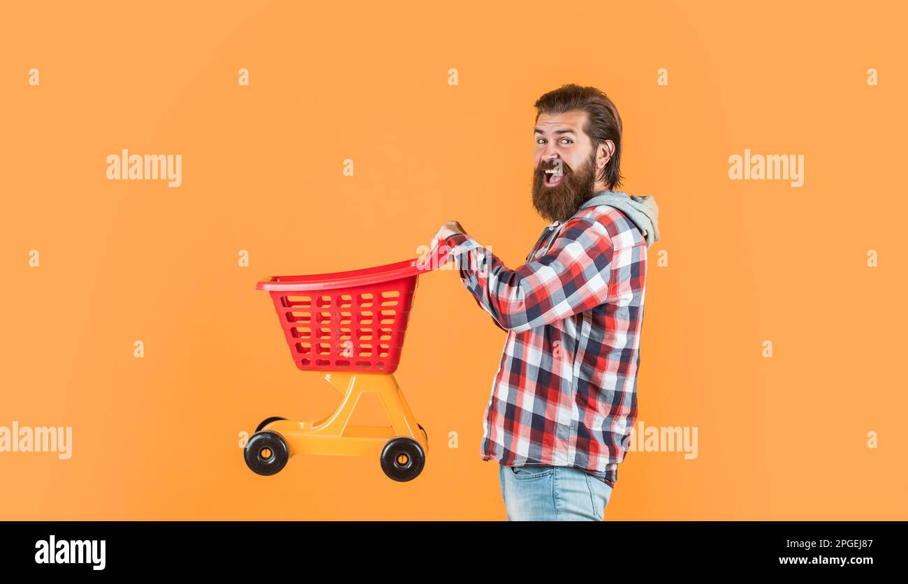 man go shopping. funny man with small shopping cart. weekend on buying ...