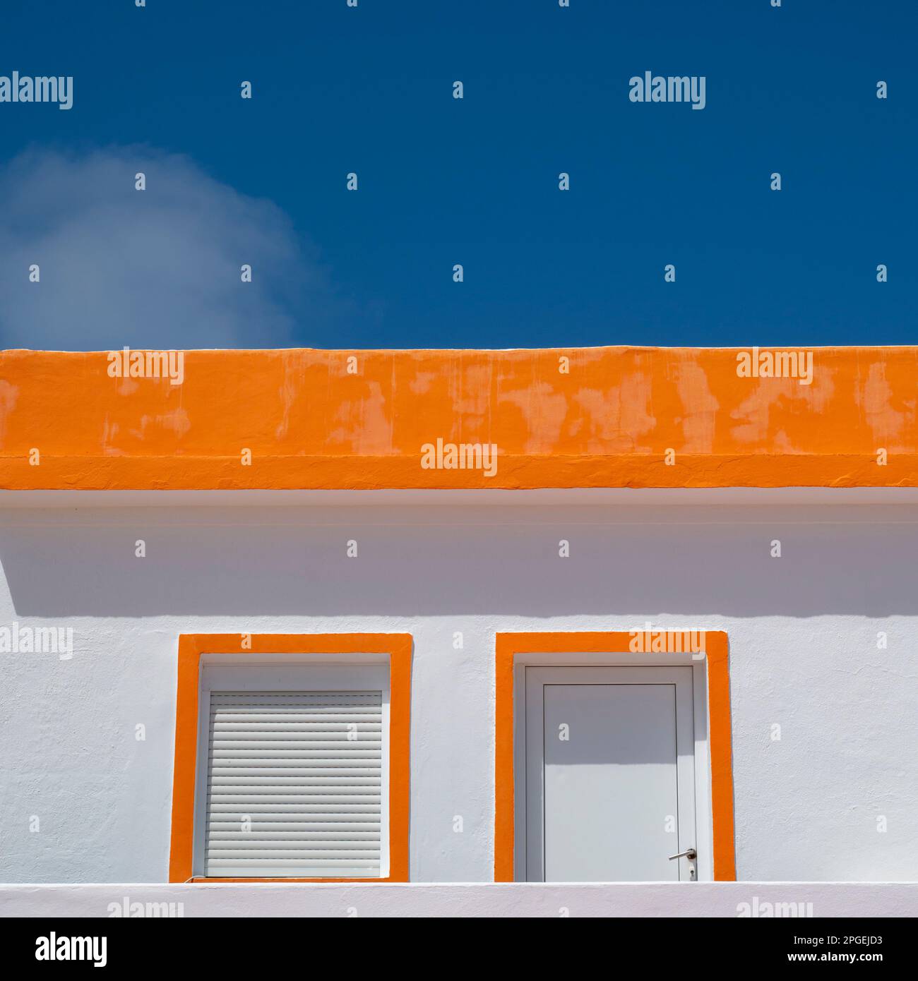 A brightly orange and white coloured house in the Algarve Portugal in ...