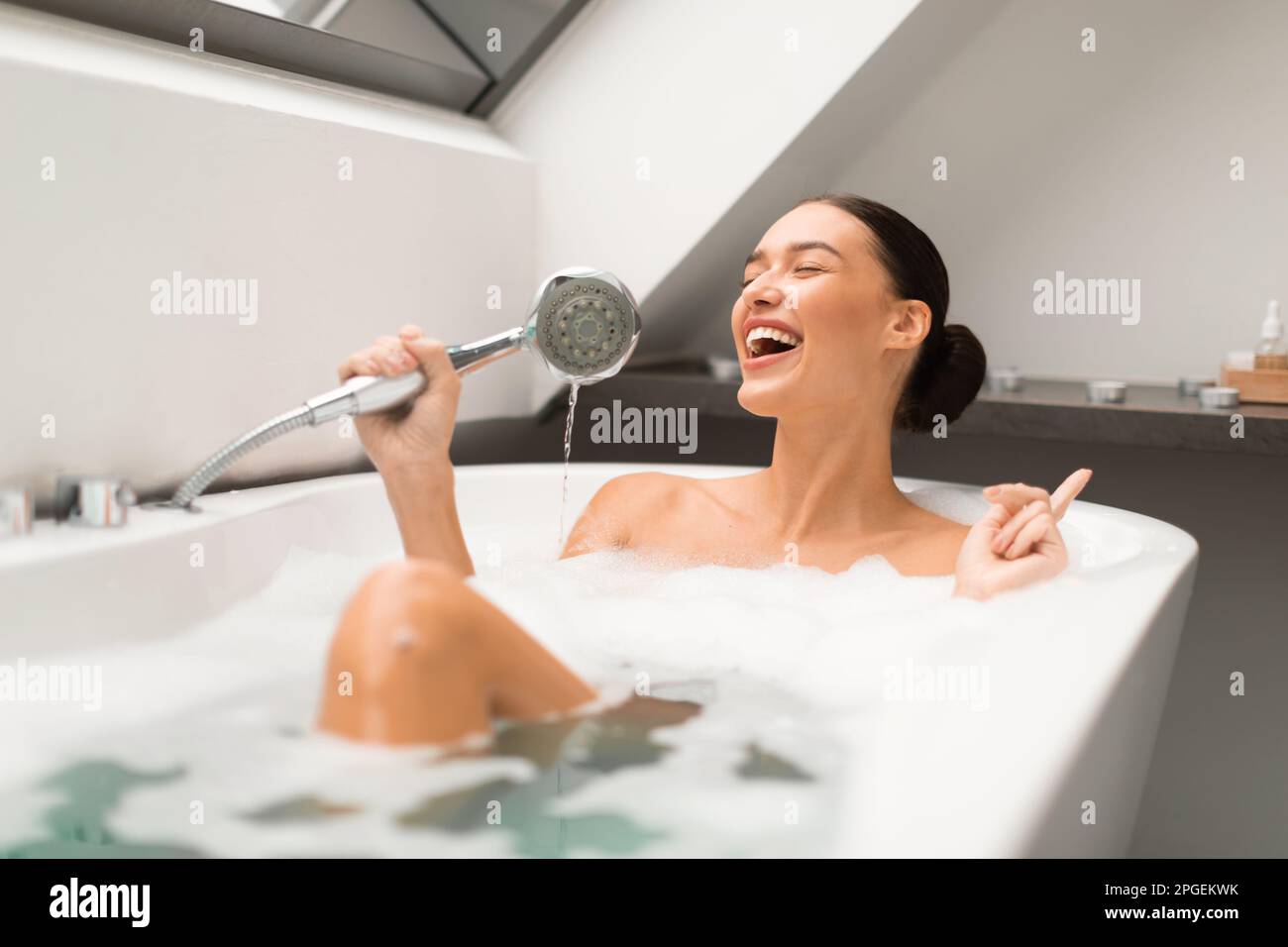 Lady Having Fun Taking Bath And Singing In Modern Bathroom Stock Photo ...