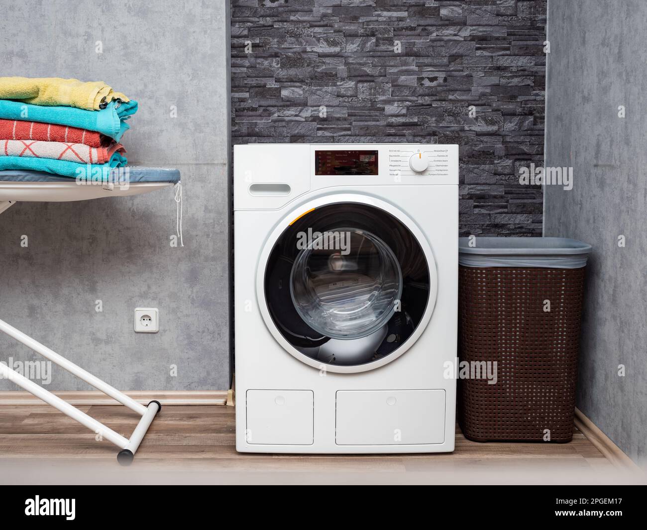 Laundry room interior with washing machine against the wall. Modern ...