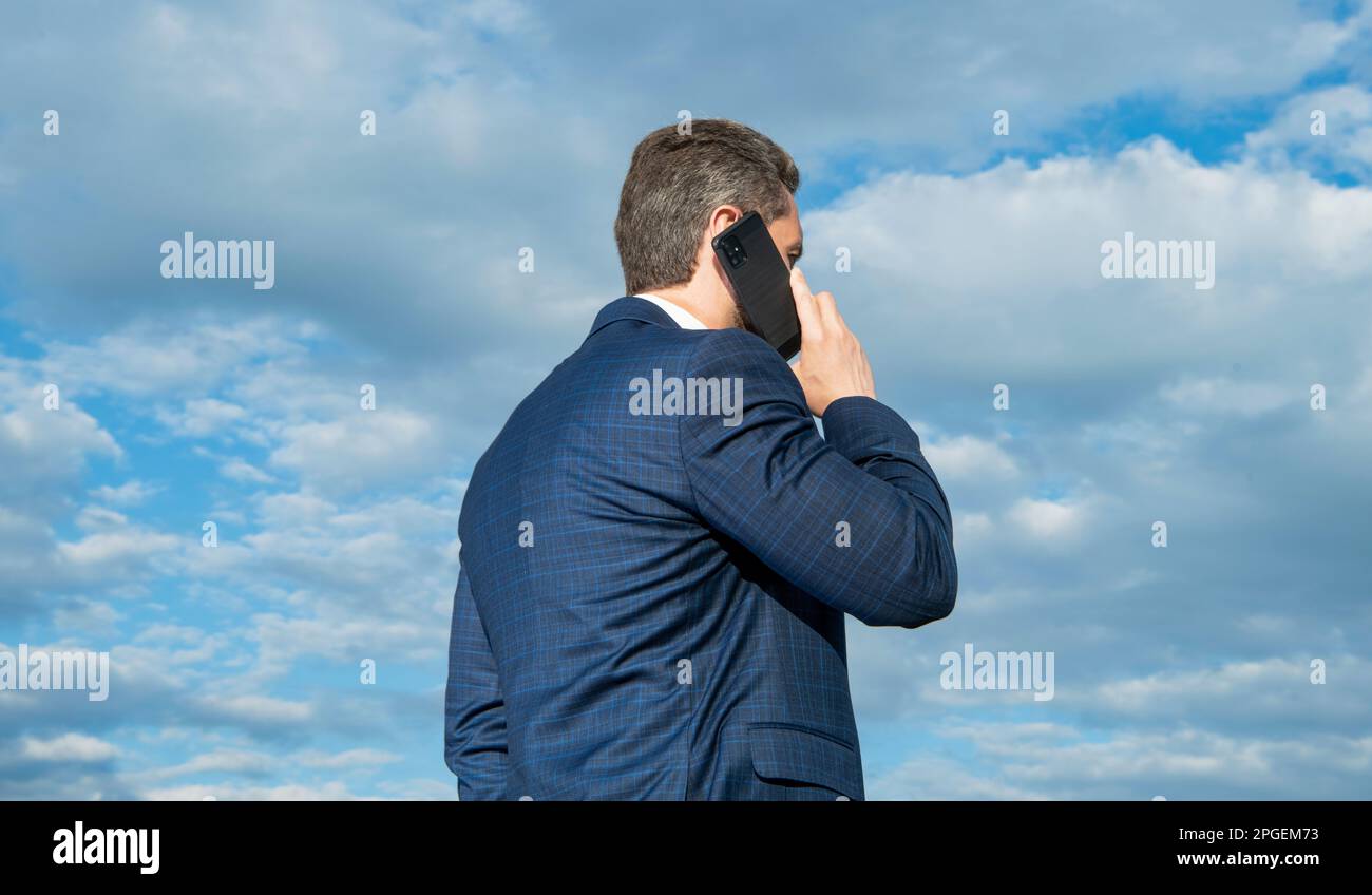 back view of man has phone talk wear suit. photo of man has phone talk ...