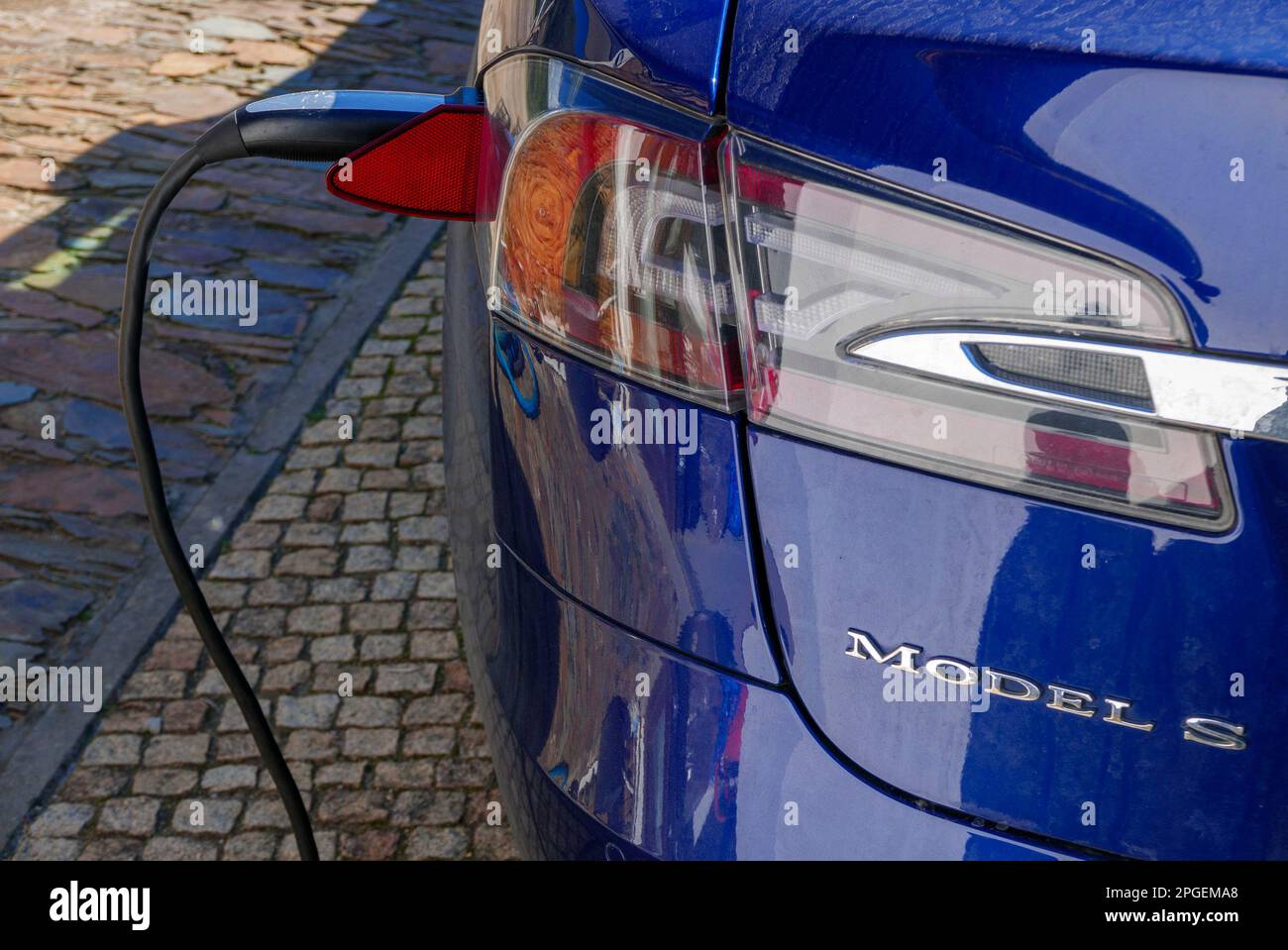 Blue Tesla model S charging Stock Photo - Alamy