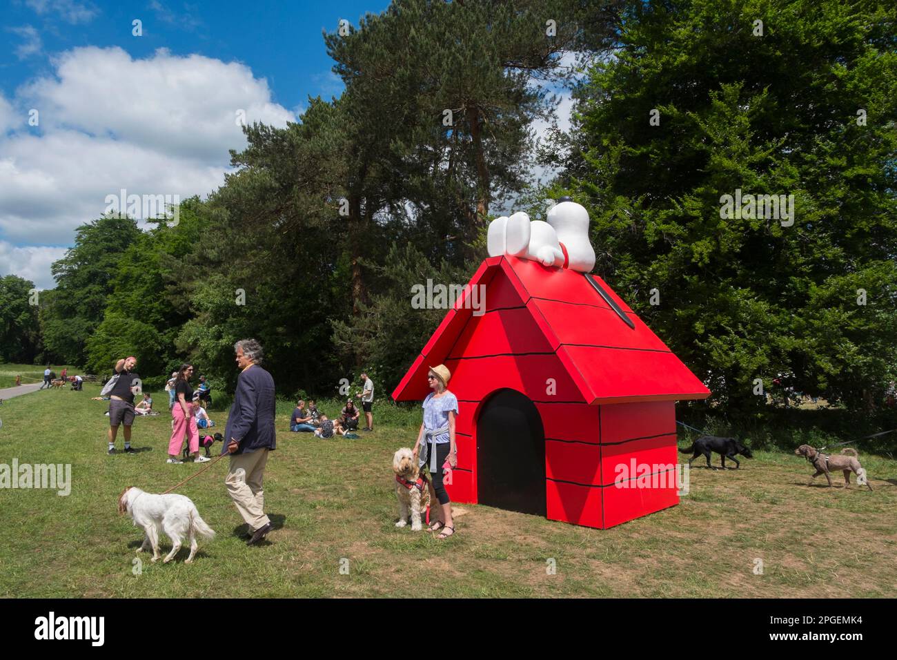 People taking selfies with their dogs standing in front of a massive ...