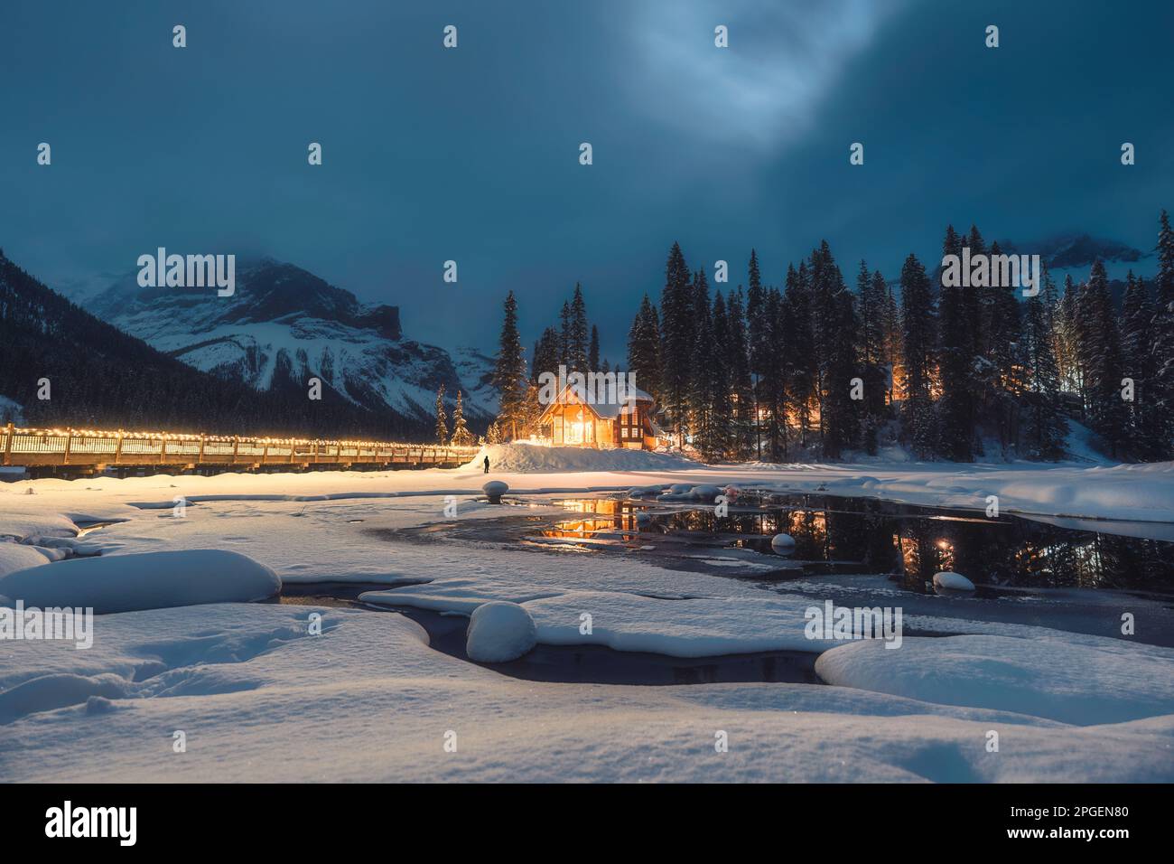 Beautiful scenery of Frozen Emerald Lake with wooden lodge glowing in ...