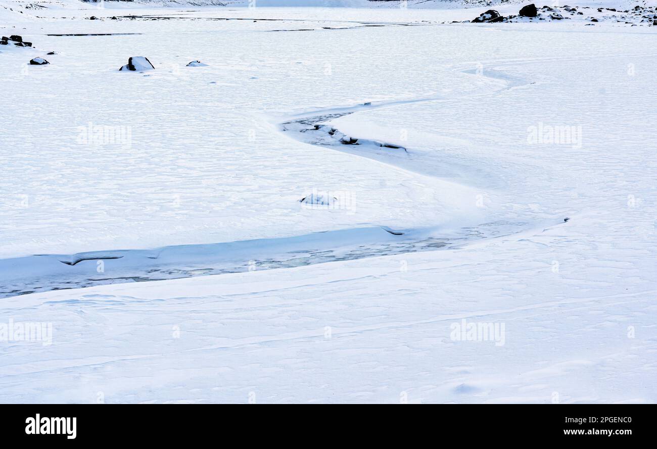 Snow covered frozen lake and winding stream in winter Stock Photo - Alamy