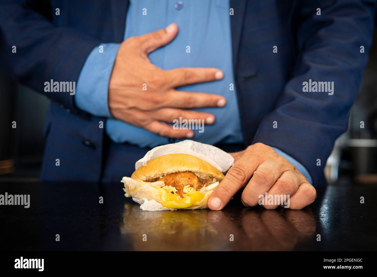 Concept of eating unhealthy food. man holding fatty hamburger and ...