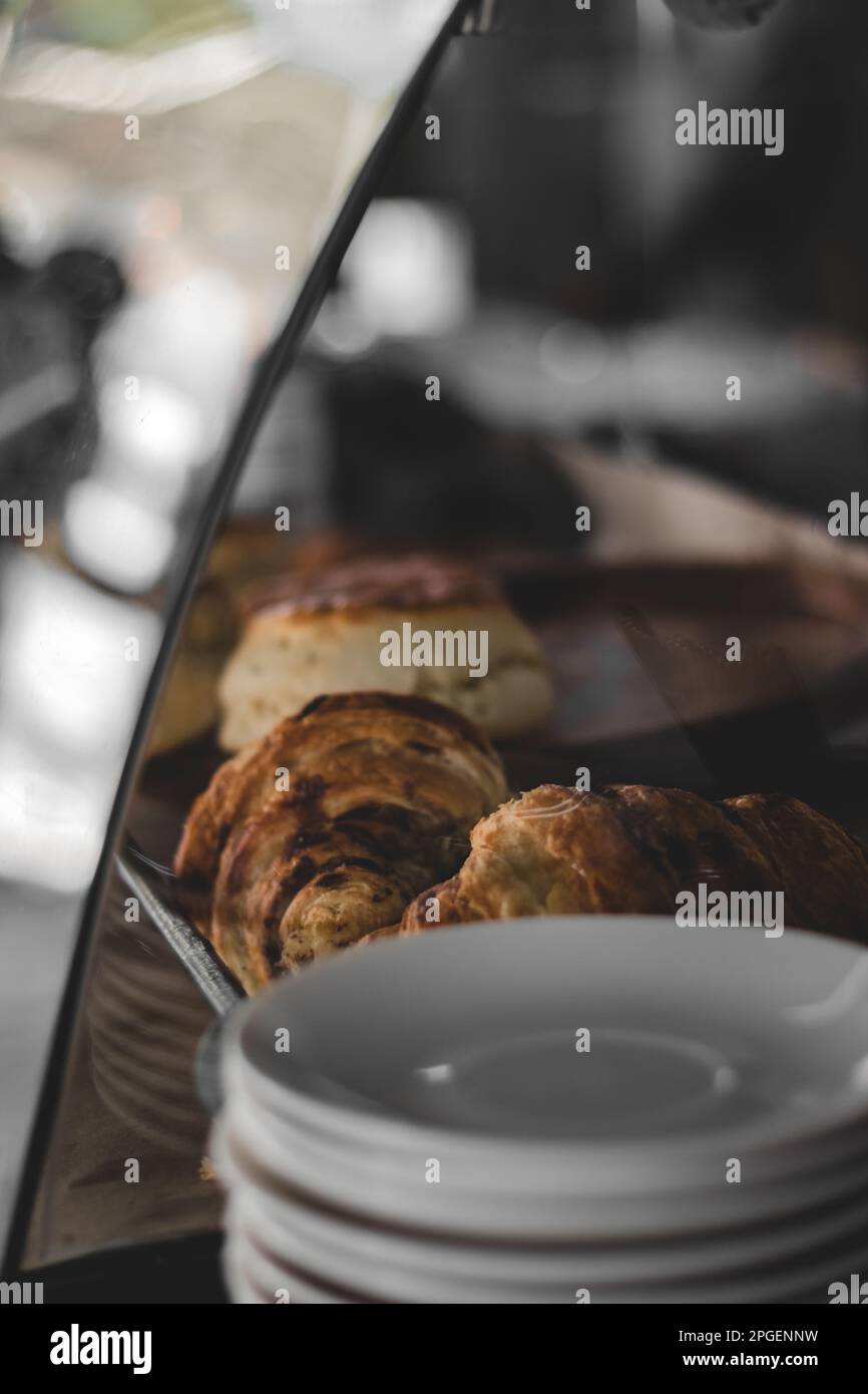 A close-up view of a pastry counter with freshly made pastries ...