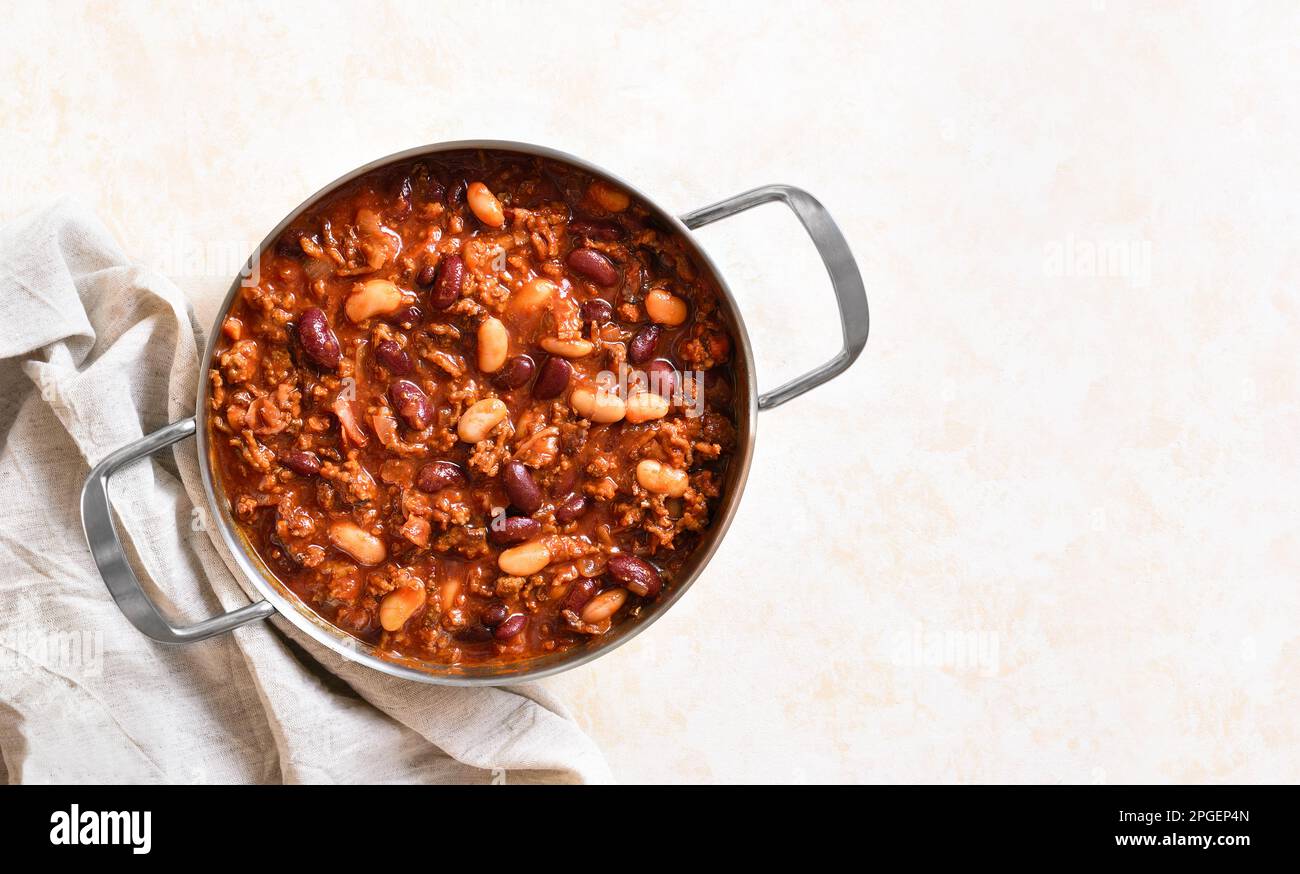 Cowboy beans with ground beef, jalapeno pepper and bacon in cooking pan ...