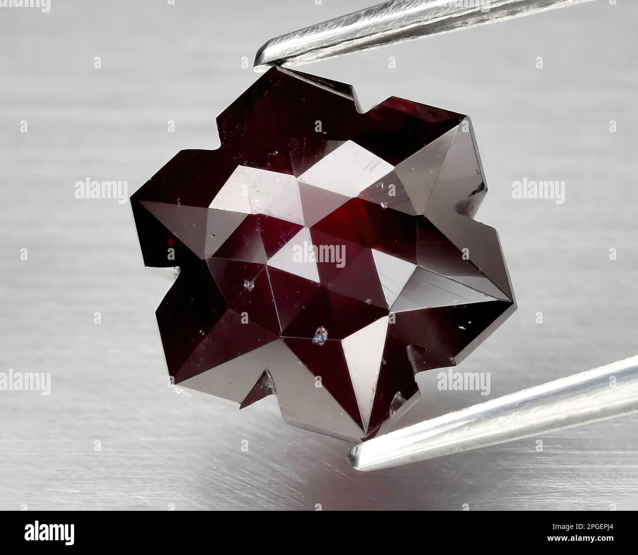 Natural gem red rhodolite garnet on gray background Stock Photo - Alamy