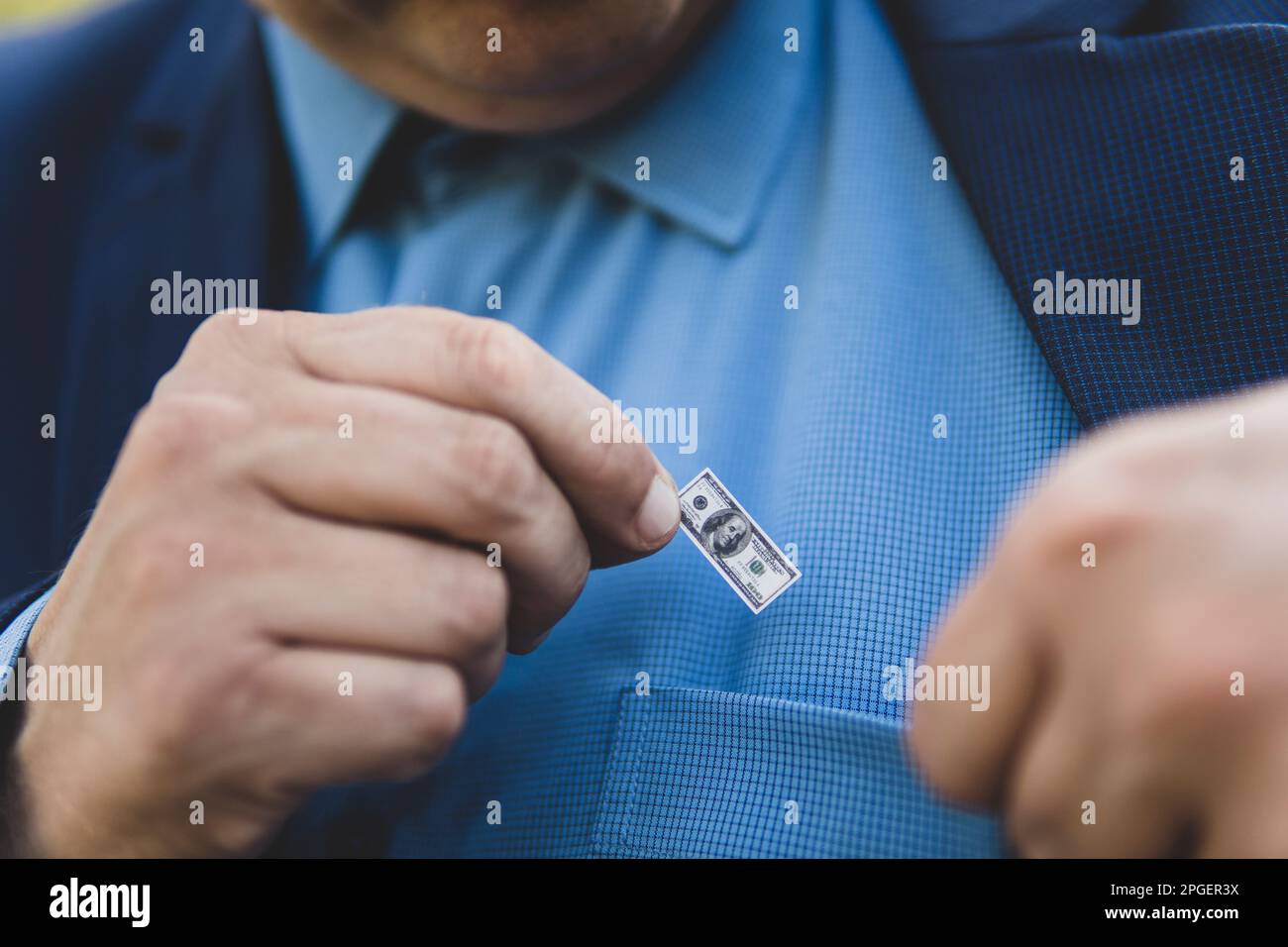 the concept of inflation and falling incomes. a small hundred-dollar ...