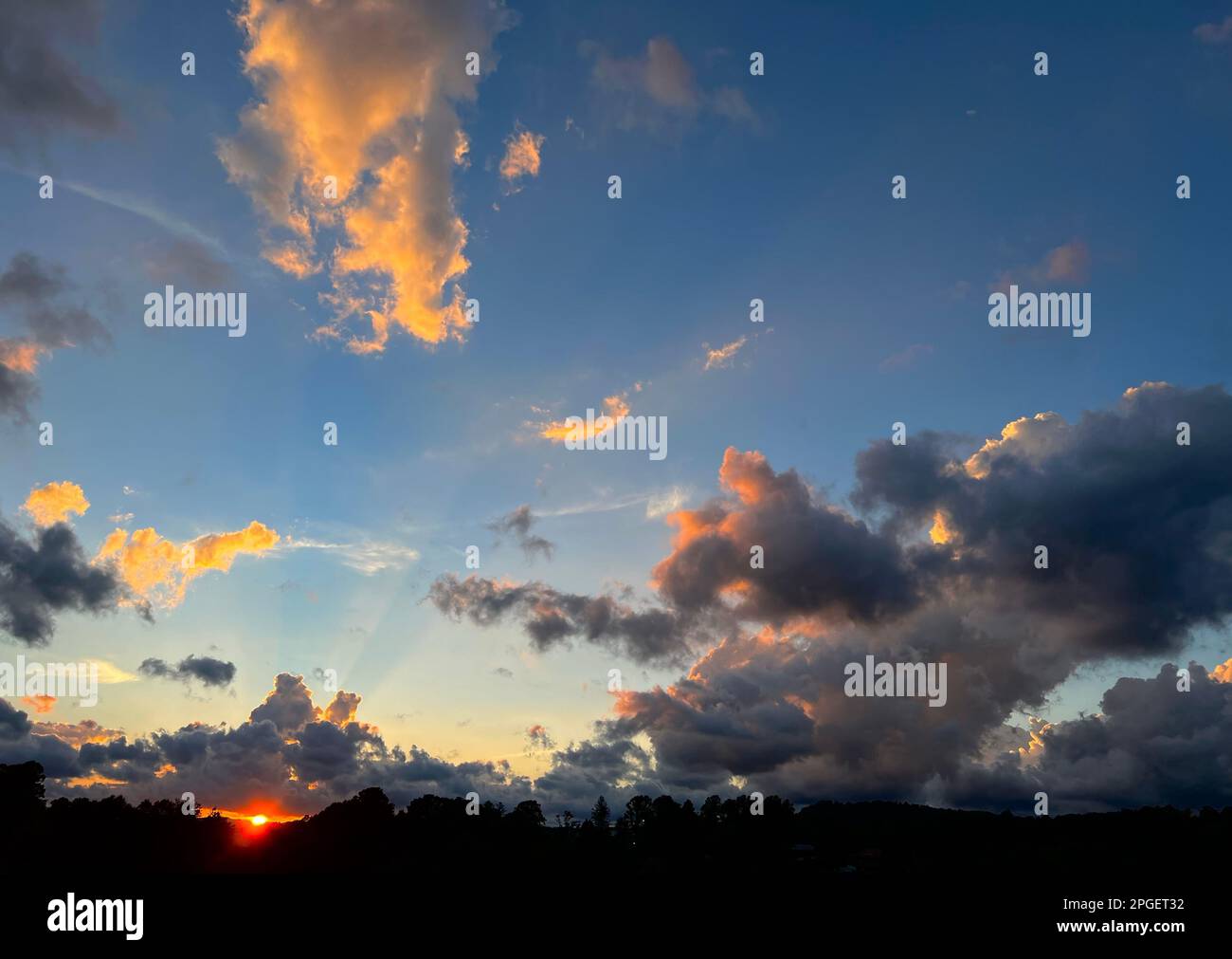 A breathtaking view of a bright sunset sky with a glowing sun and ...
