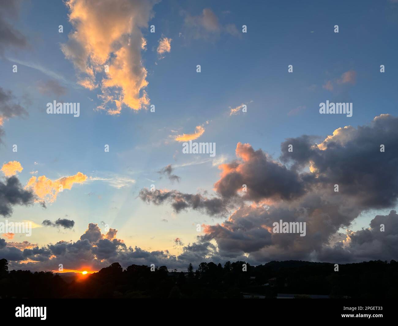 A breathtaking view of a bright sunset sky with a glowing sun and ...