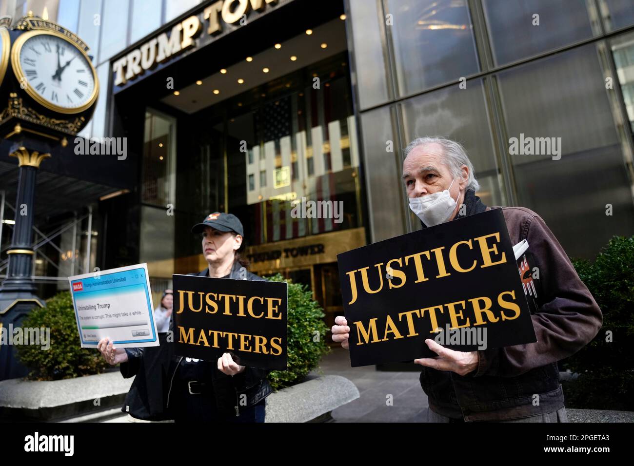 Kathleen Zea, left, and Daniel Olsen, right, hold signs protesting ...