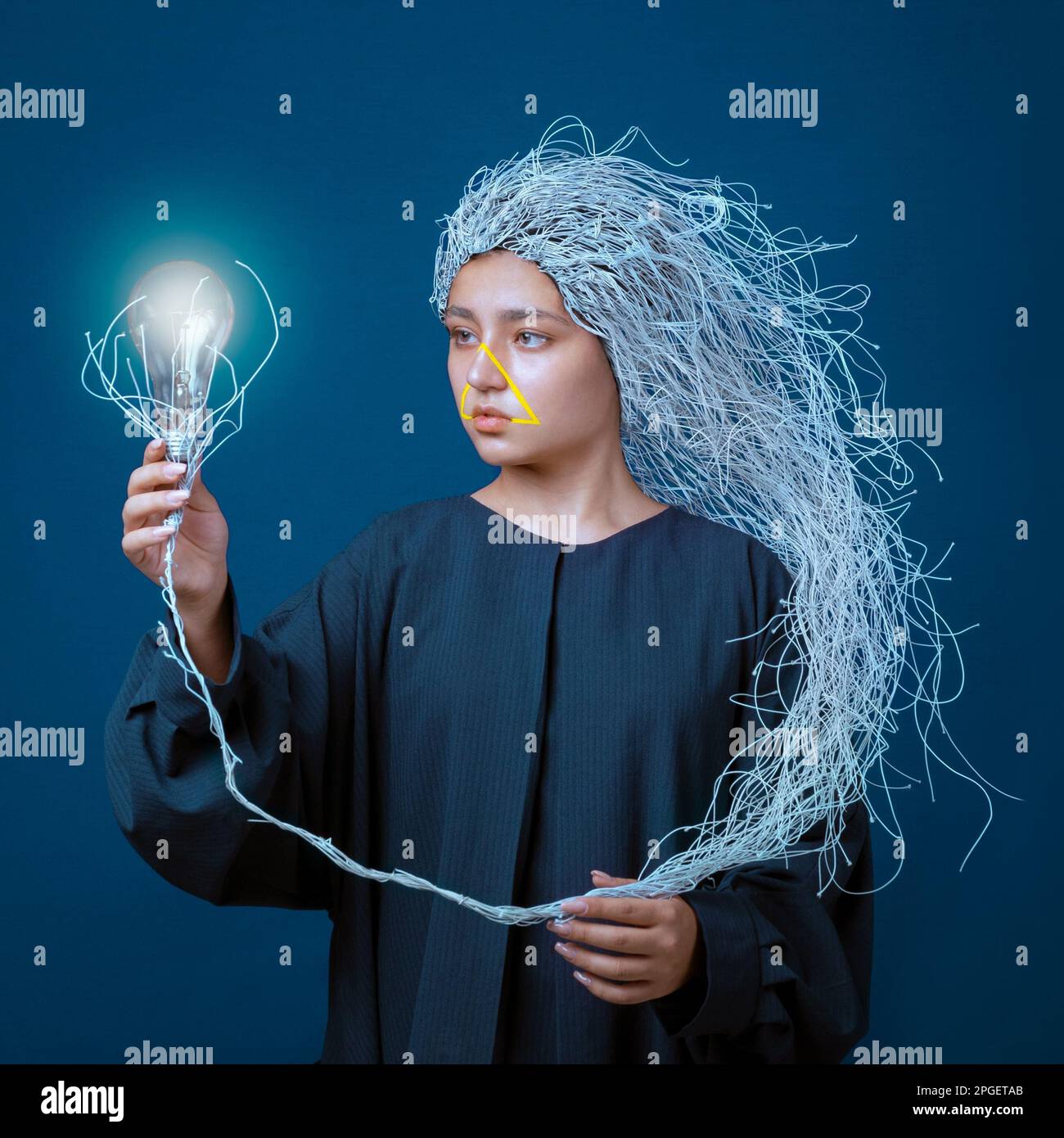 A young female with hair from barbed wires holding a light bulb in her ...