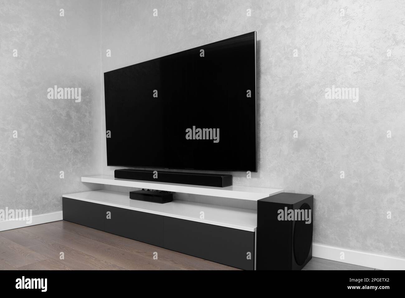 Part of the interior of the living room with a TV on the wall, hifi ...