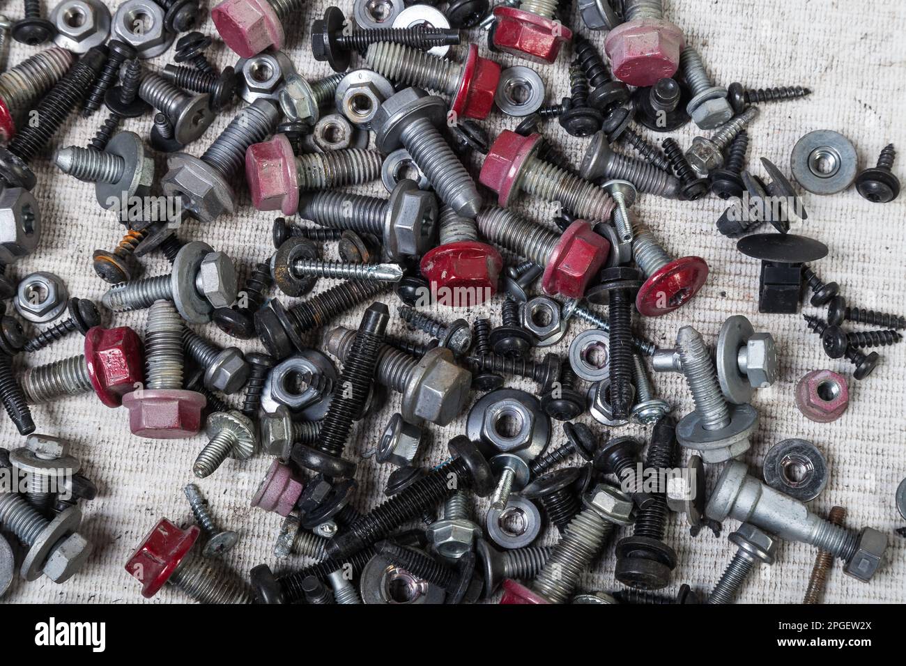 Background of bolts and nuts of different lengths and threads. Industry ...