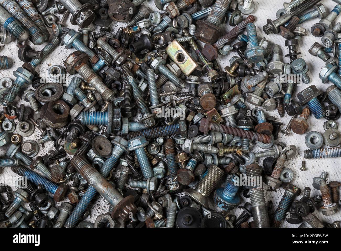 Background of bolts and nuts of different lengths and threads. Industry ...