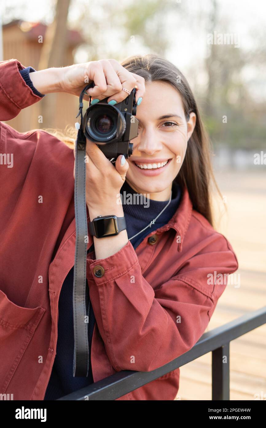 Close up of a smily woman taking picture outside with her vintage ...