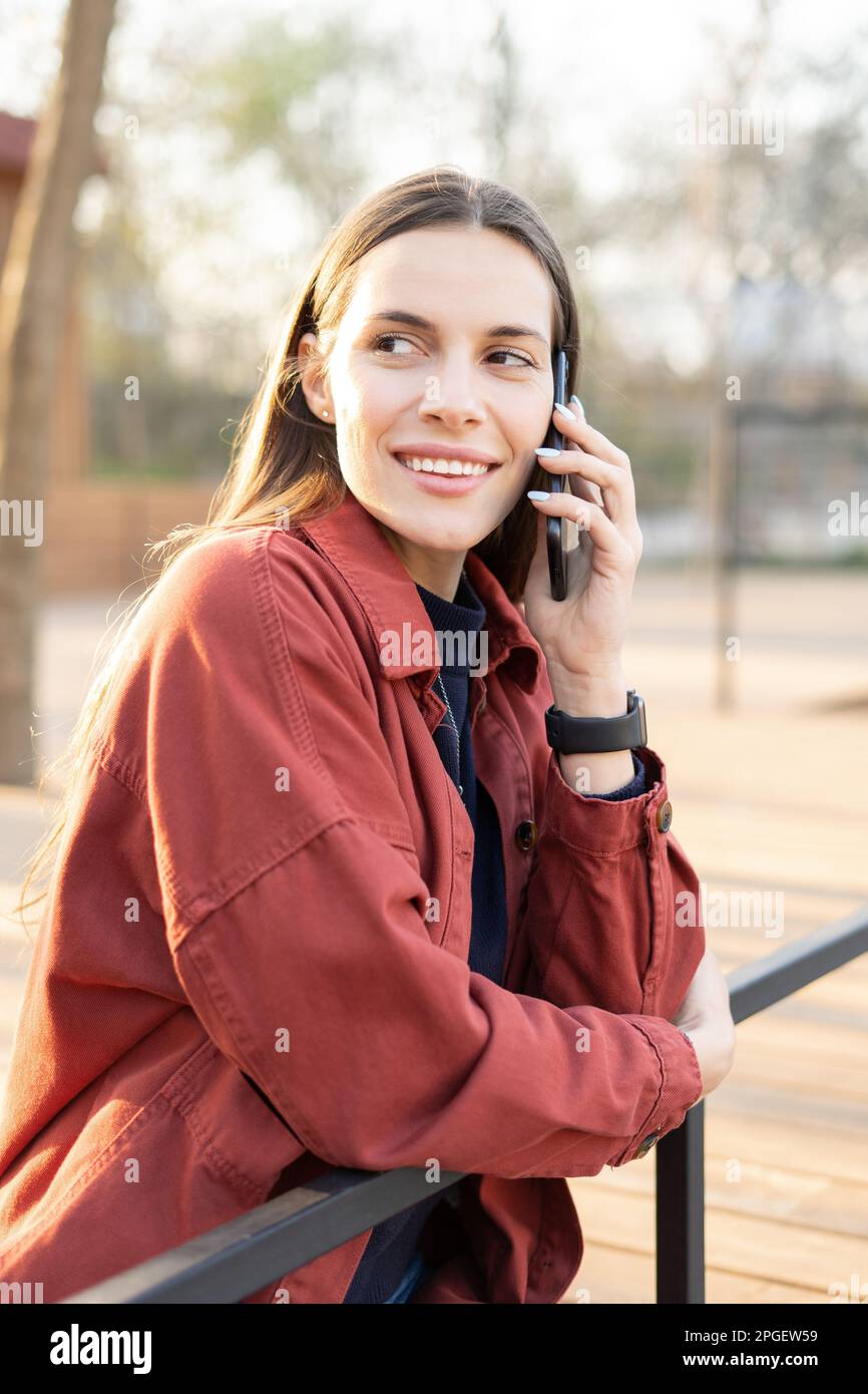 Lively middle aged woman talking on her mobile phone with a stunning ...