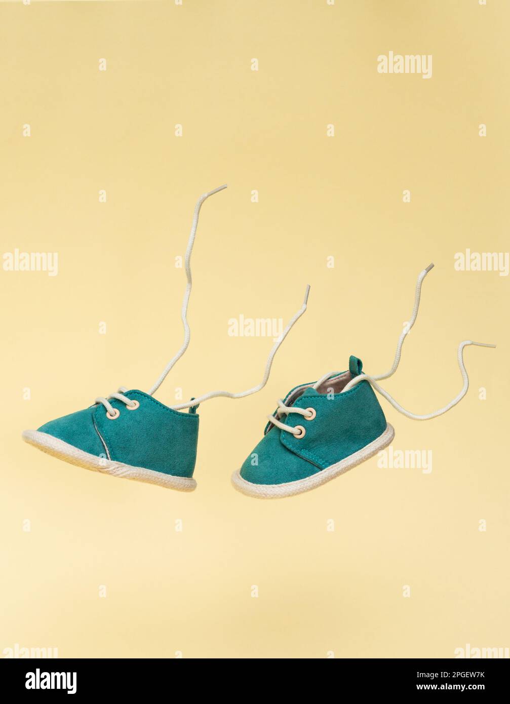 Flying baby shoes with flying laces. Newborn baby concept with ...