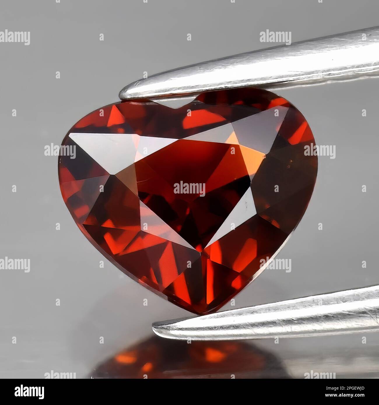 Natural gem red spessartine garnet on a gray background Stock Photo - Alamy