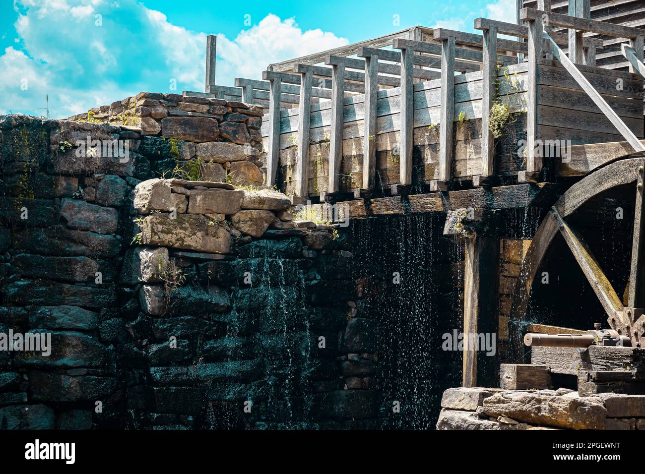 A traditional wooden water wheel set in a picturesque countryside Yates ...