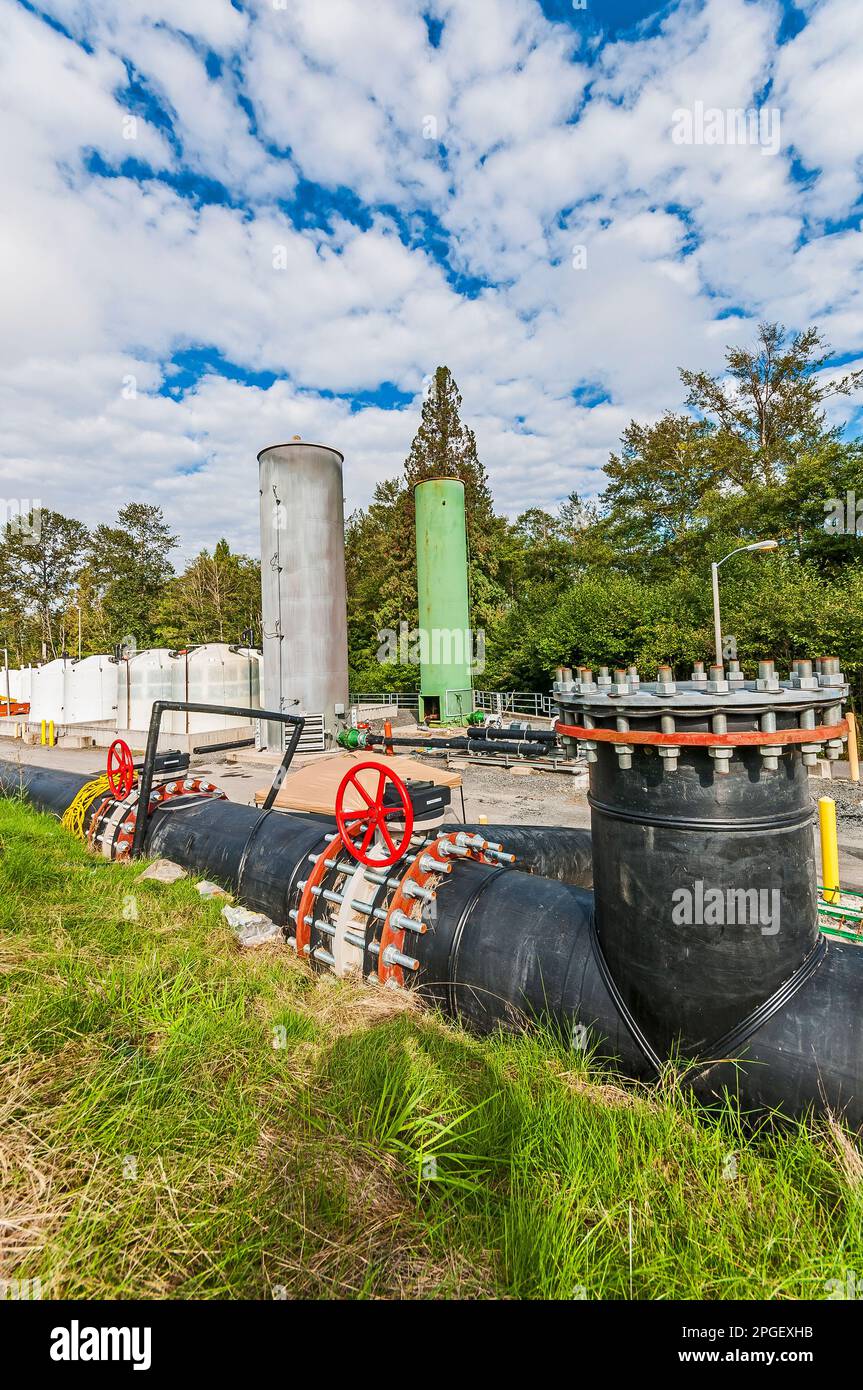 A large pipe with multi-bolt and nut flanges plus valving in the ...