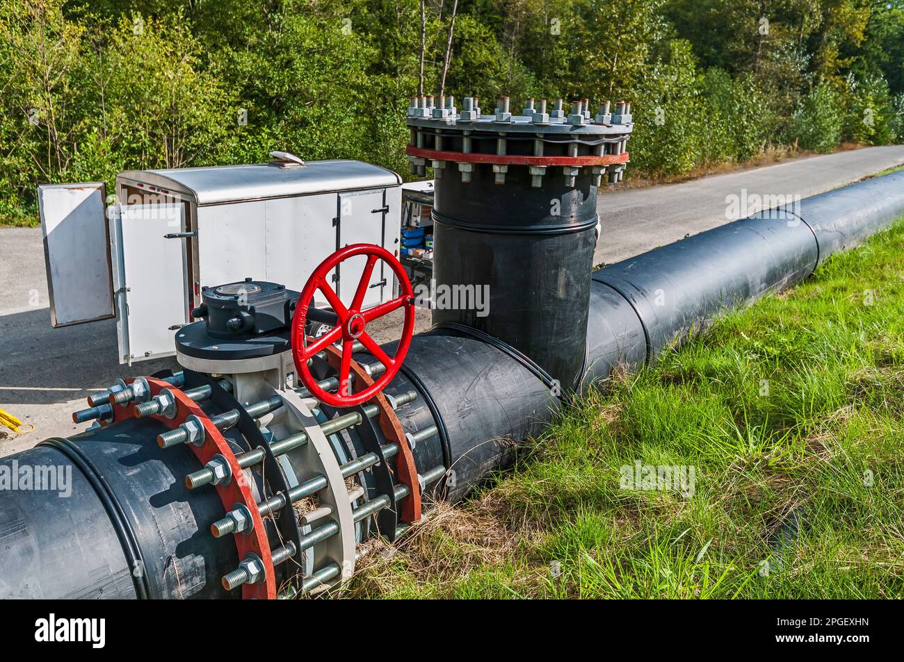 A large pipe with multi-bolt and nut flanges plus valving in the ...