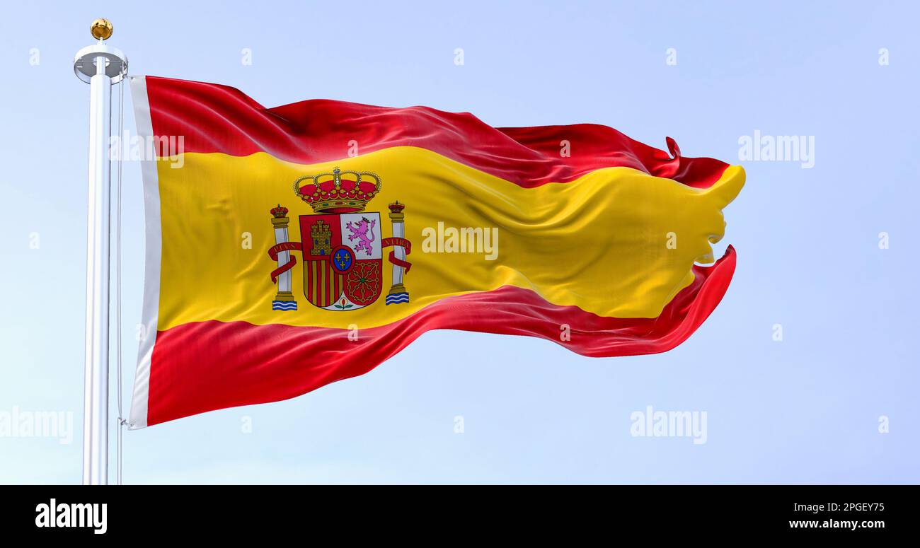 The national flag of Spain waving in the wind in a clear day. European ...