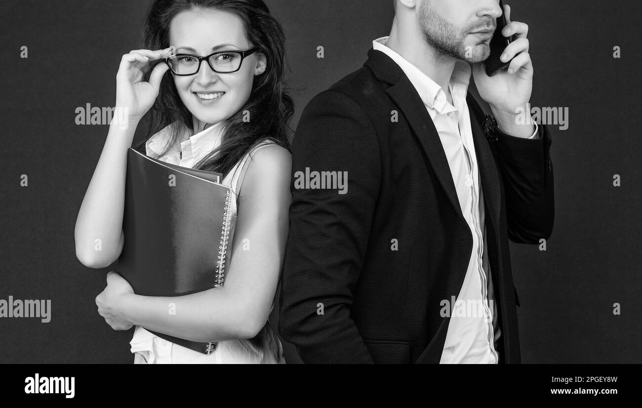 Be professional. Woman holding files while man talking on phone ...