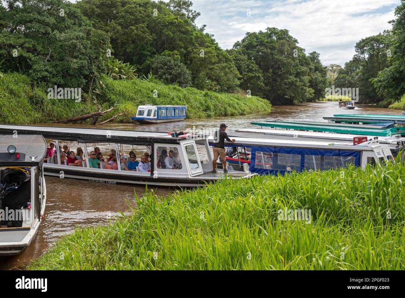 La Pavona, Costa Rica - Tourists ride boats on the Suerte River for the ...