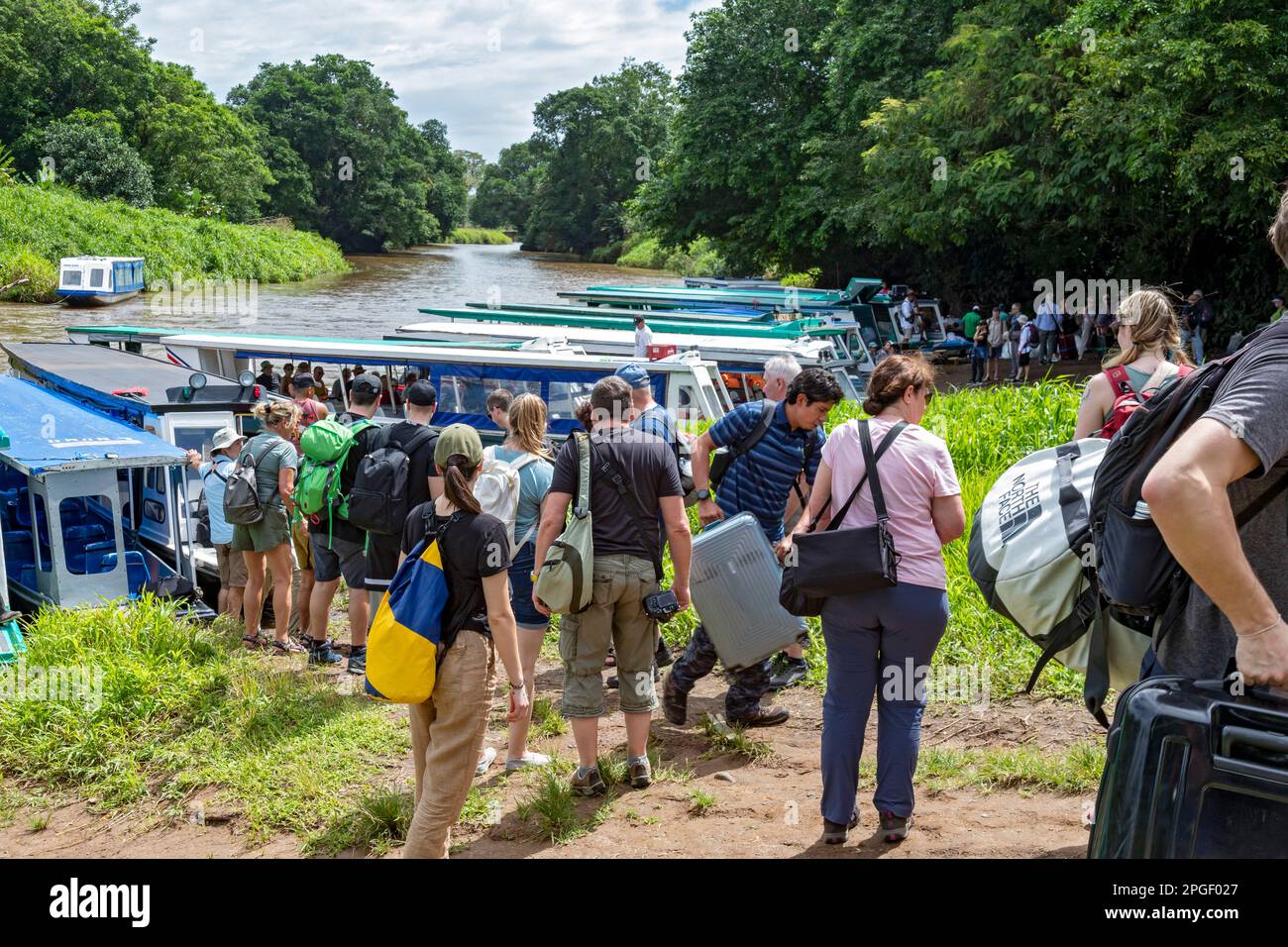 La Pavona, Costa Rica - Tourists board boats on the Suerte River for ...