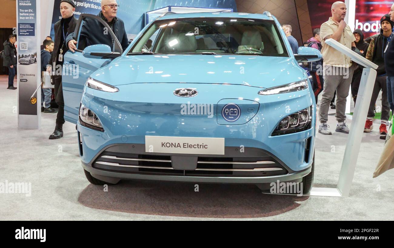 Crowds looking at new car models at Auto show. Hyundai Kona electric ...