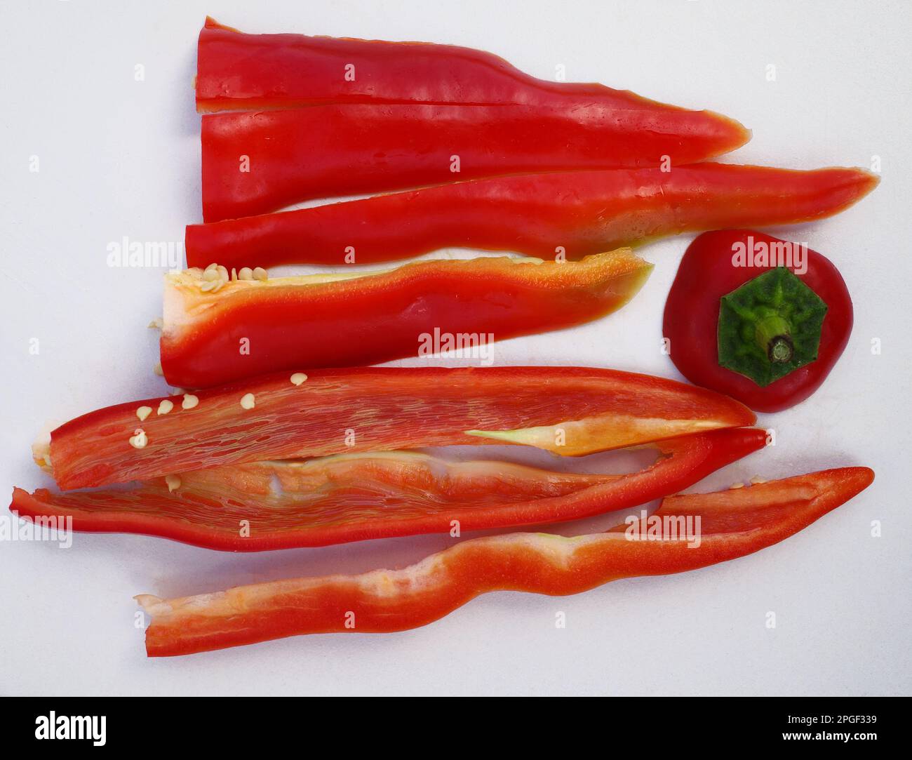 Sliced red sweet capsicum annuum on a white cutting board Stock Photo ...