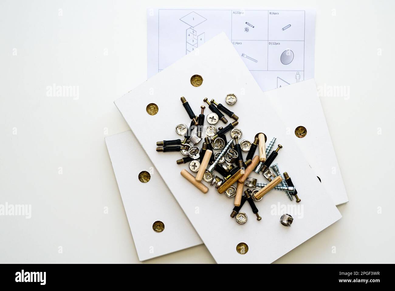 Furniture fittings. A pile of a various assembly fittings on a white ...