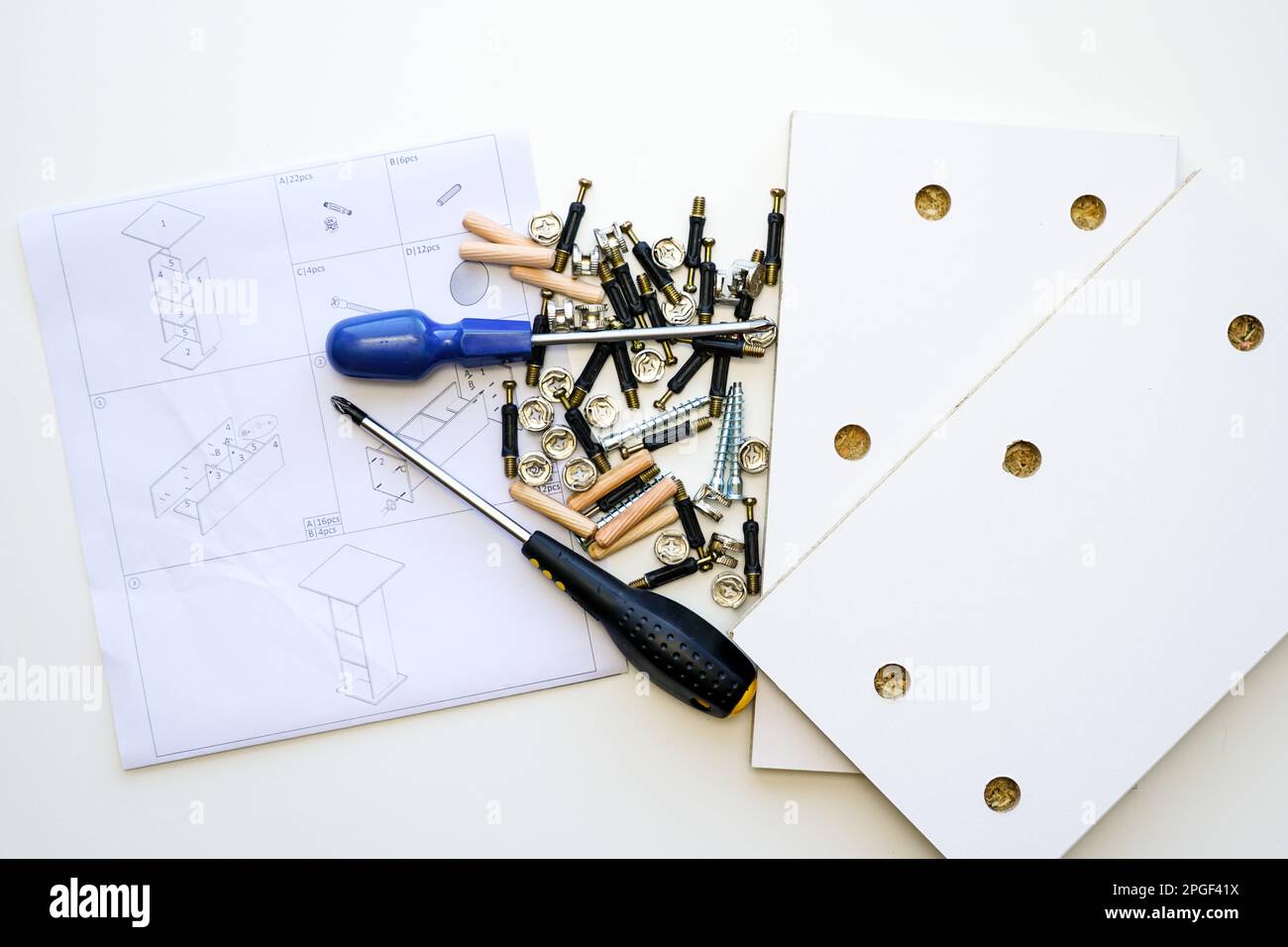 Furniture fittings. A pile of a various assembly fittings on a white ...