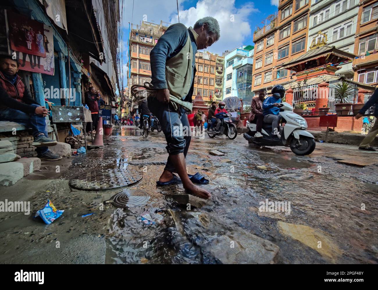 Kathmandu, Bagmati, Nepal. 22nd Mar, 2023. A man washes his feet in the flowing water after the ...