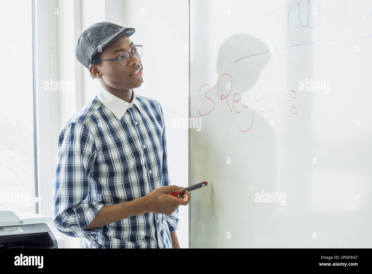 University student explains on whiteboard School, Bavaria, Germany ...