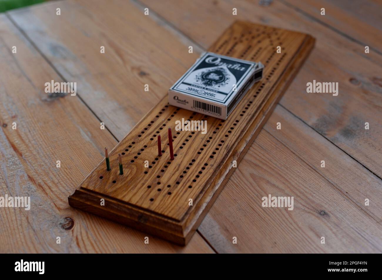 A cribbage board and a deck of cards is made available on a picnic ...