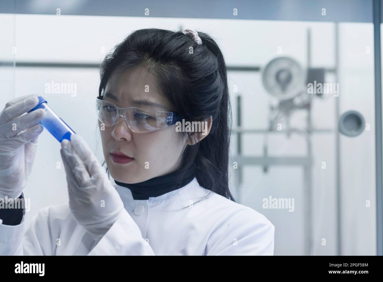 Young female scientist examining test tube in a laboratory, Freiburg im ...