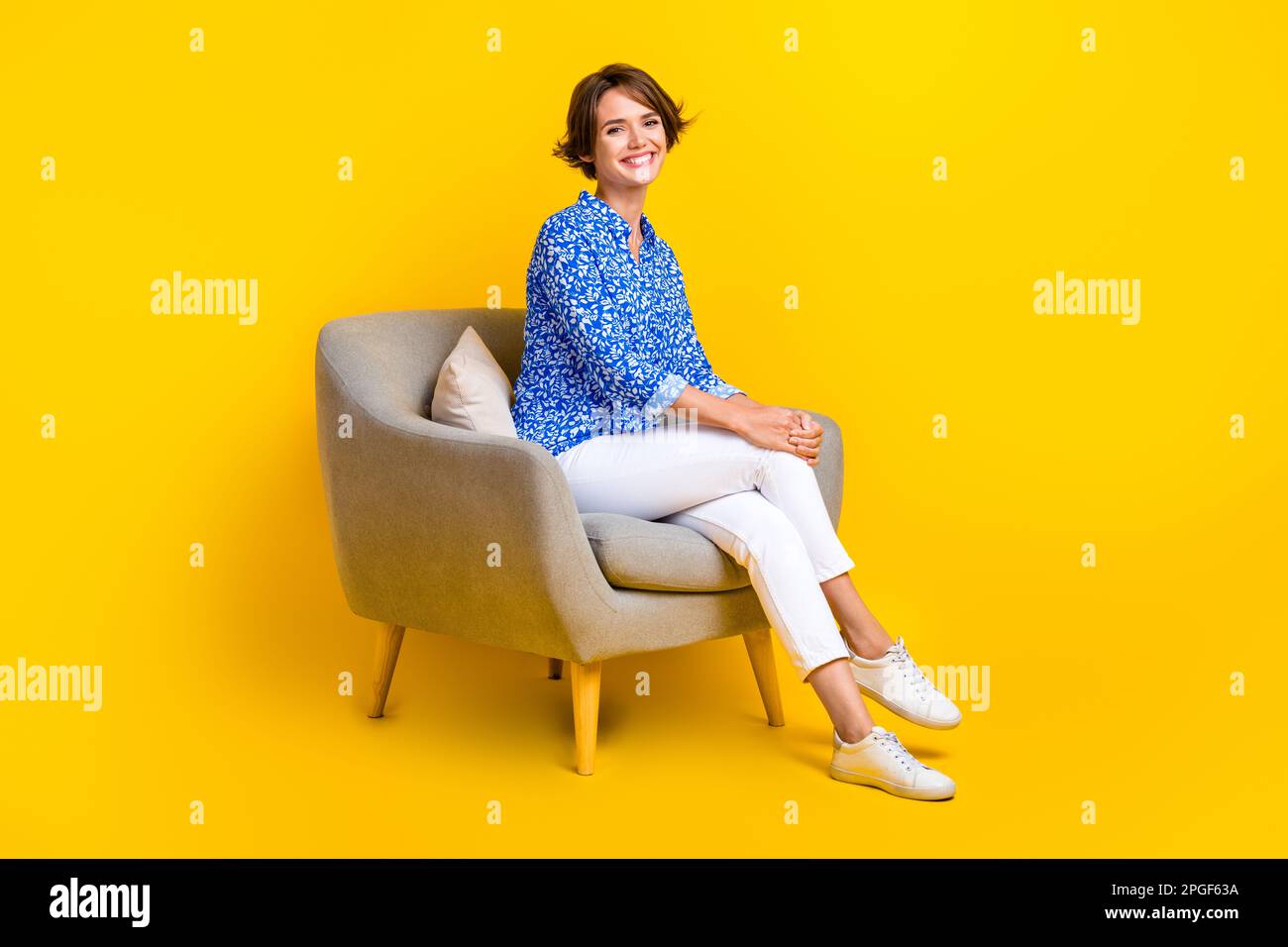 Full length photo of cute adorable lady wear print shirt sitting cozy ...